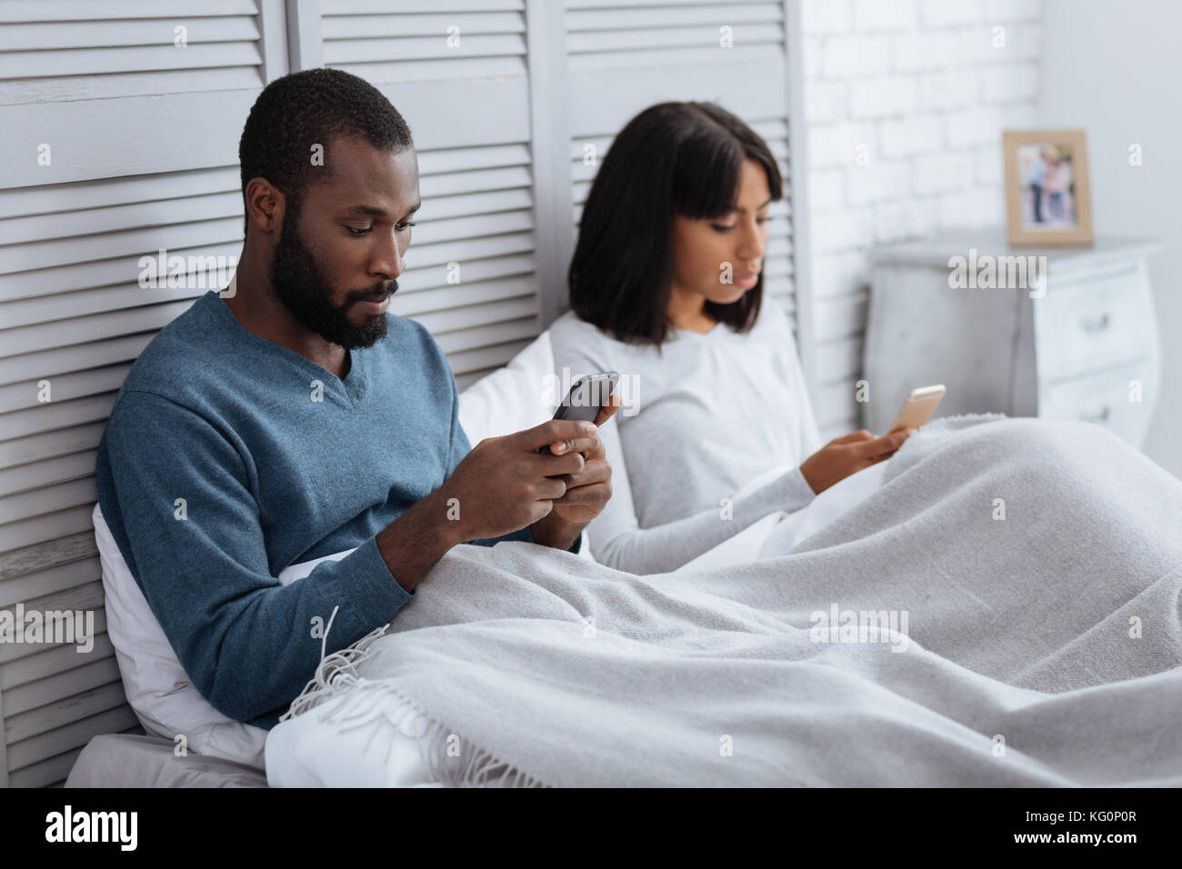 Two young people writing messages to their friends Stock Photo - Alamy