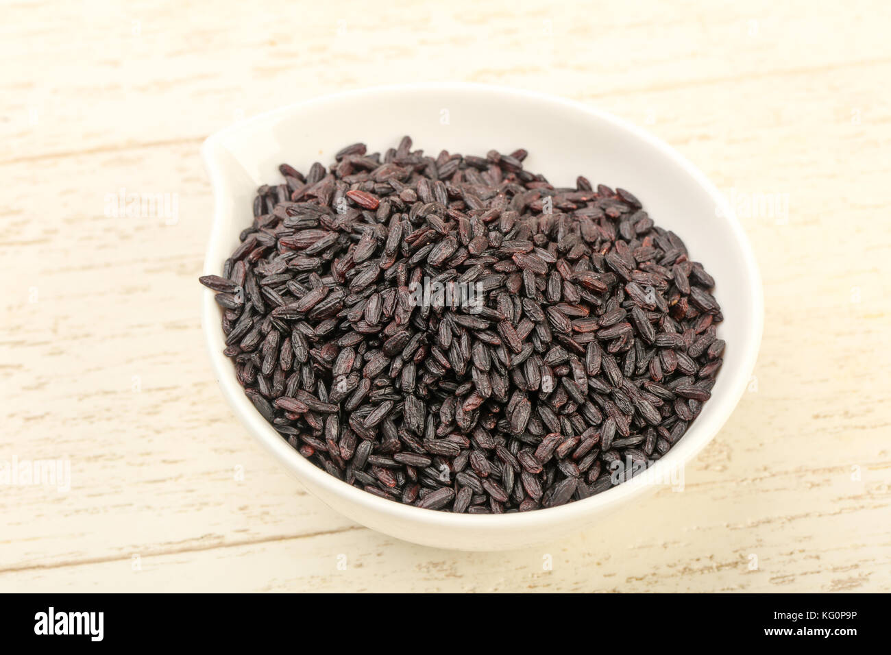 Black wild rice in the bowl over wooden background Stock Photo - Alamy