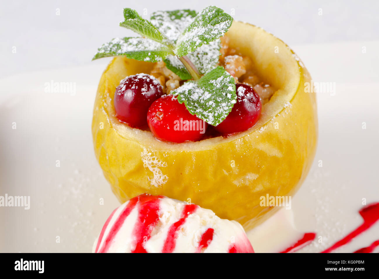 Apple stuffed nuts with ice-cream Stock Photo - Alamy