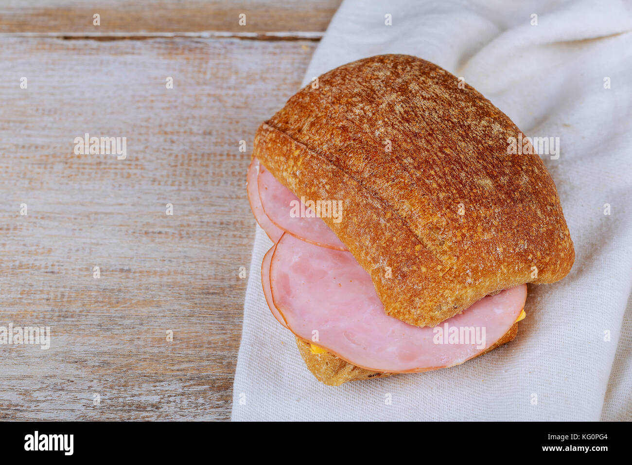 Delicious sandwich stacked high with a juicy ham on a fresh bun with ...