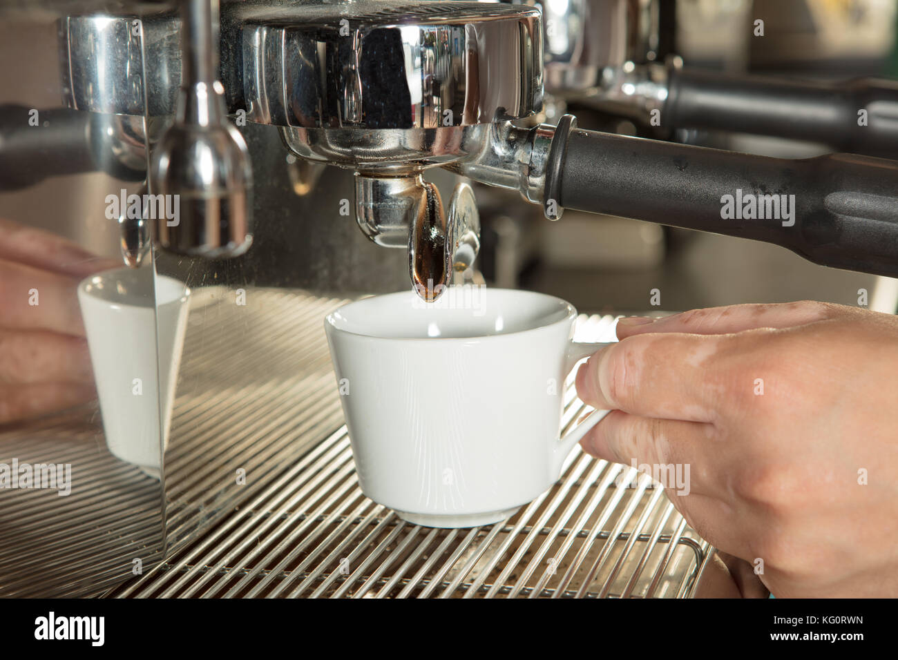 Close-up of espresso pouring from coffee machine Stock Photo - Alamy