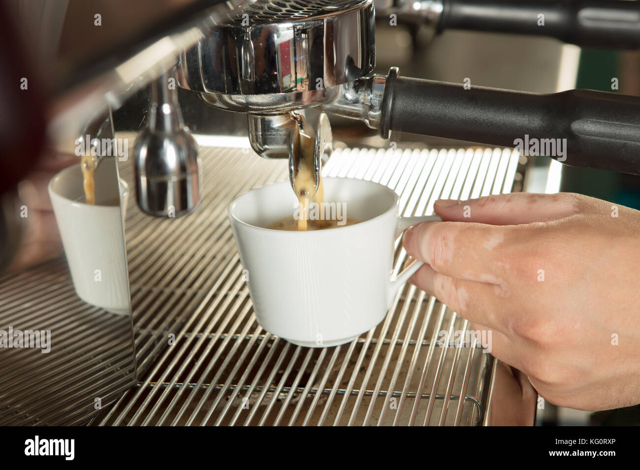 Close-up of espresso pouring from coffee machine Stock Photo - Alamy