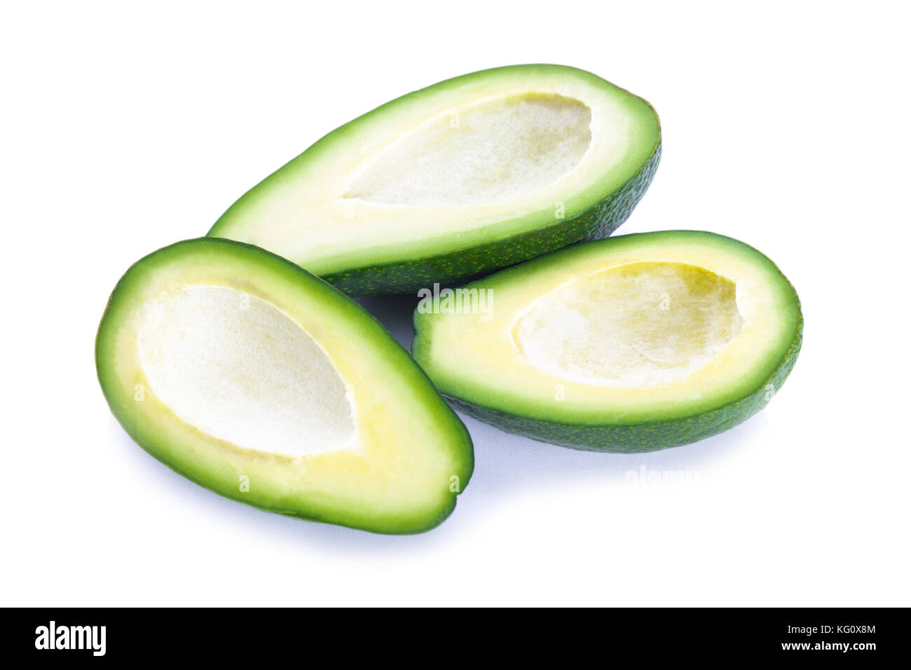 Three cut halves of avocado without pits isolated on white background ...