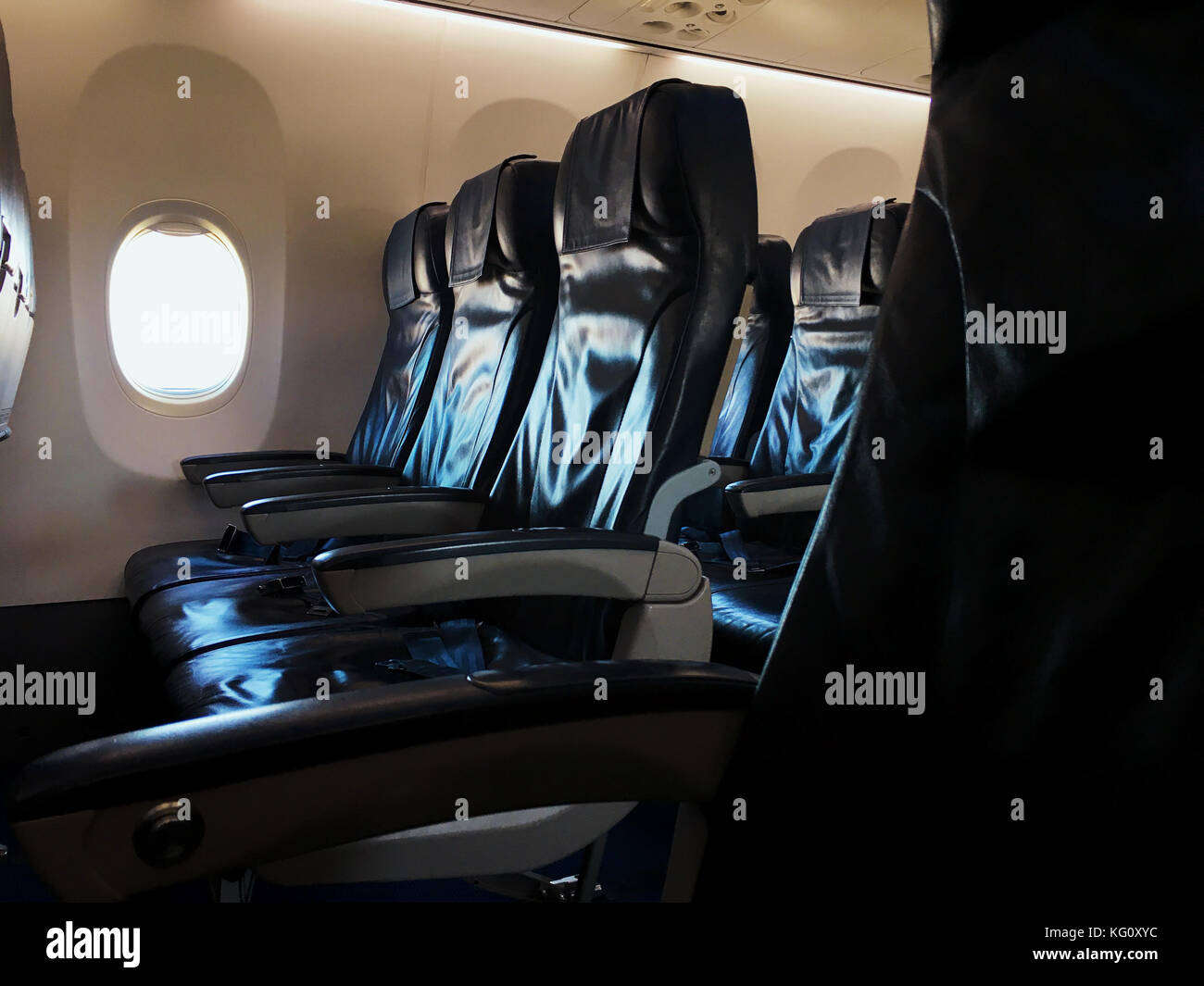 Airplane seats in the cabin economy class Stock Photo - Alamy