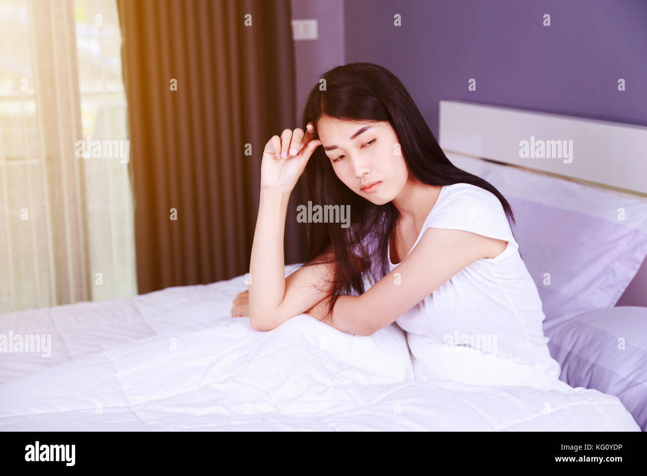 worried woman thinking on bed in the bedroom Stock Photo - Alamy