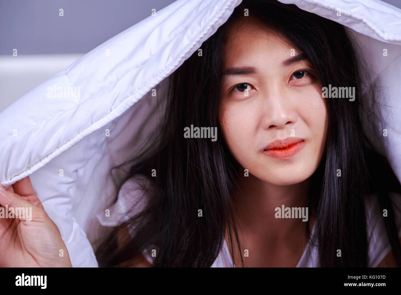 happy woman hiding under blanket on bed in the bedroom Stock Photo - Alamy