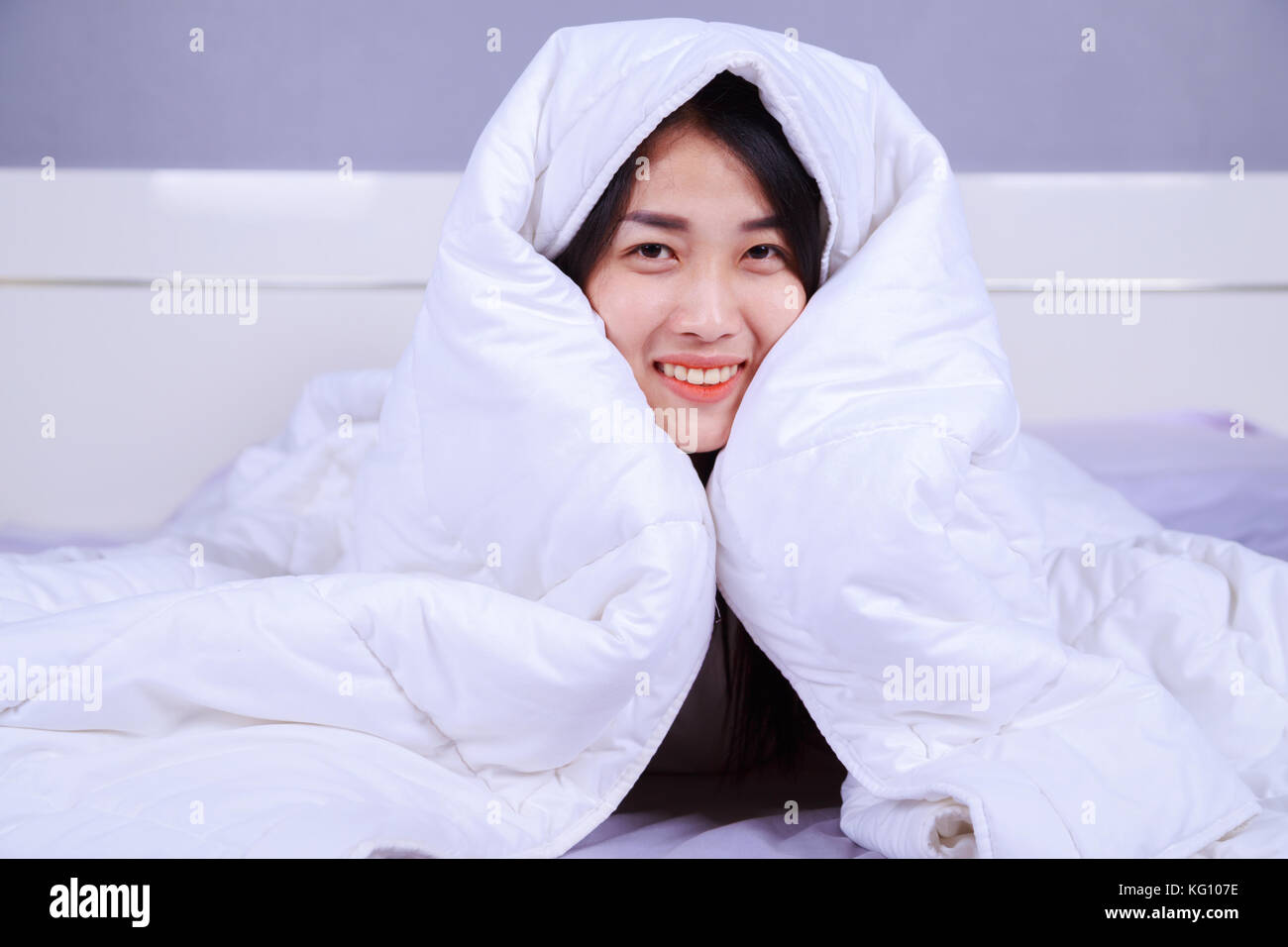 happy woman hiding under blanket on bed in the bedroom Stock Photo - Alamy