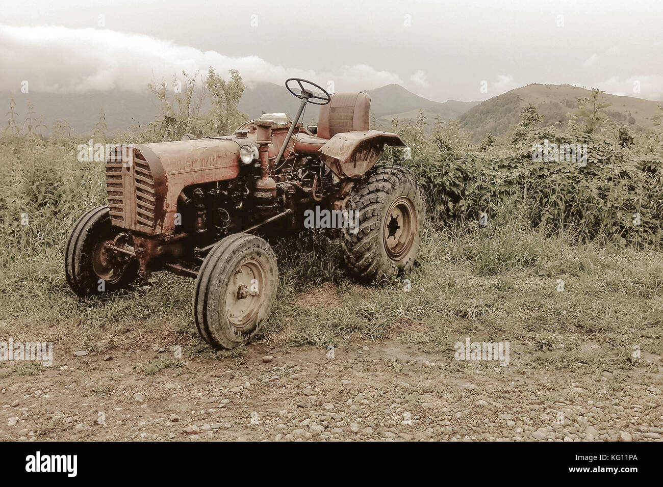Faded retro image of an old tractor parked at the roadside in the ...