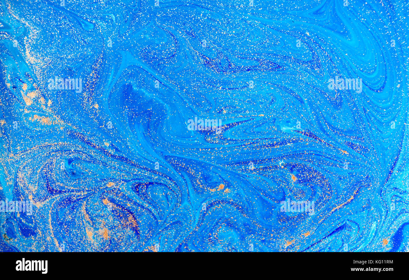 Marbled blue abstract background with golden sequins. Liquid marble ink ...