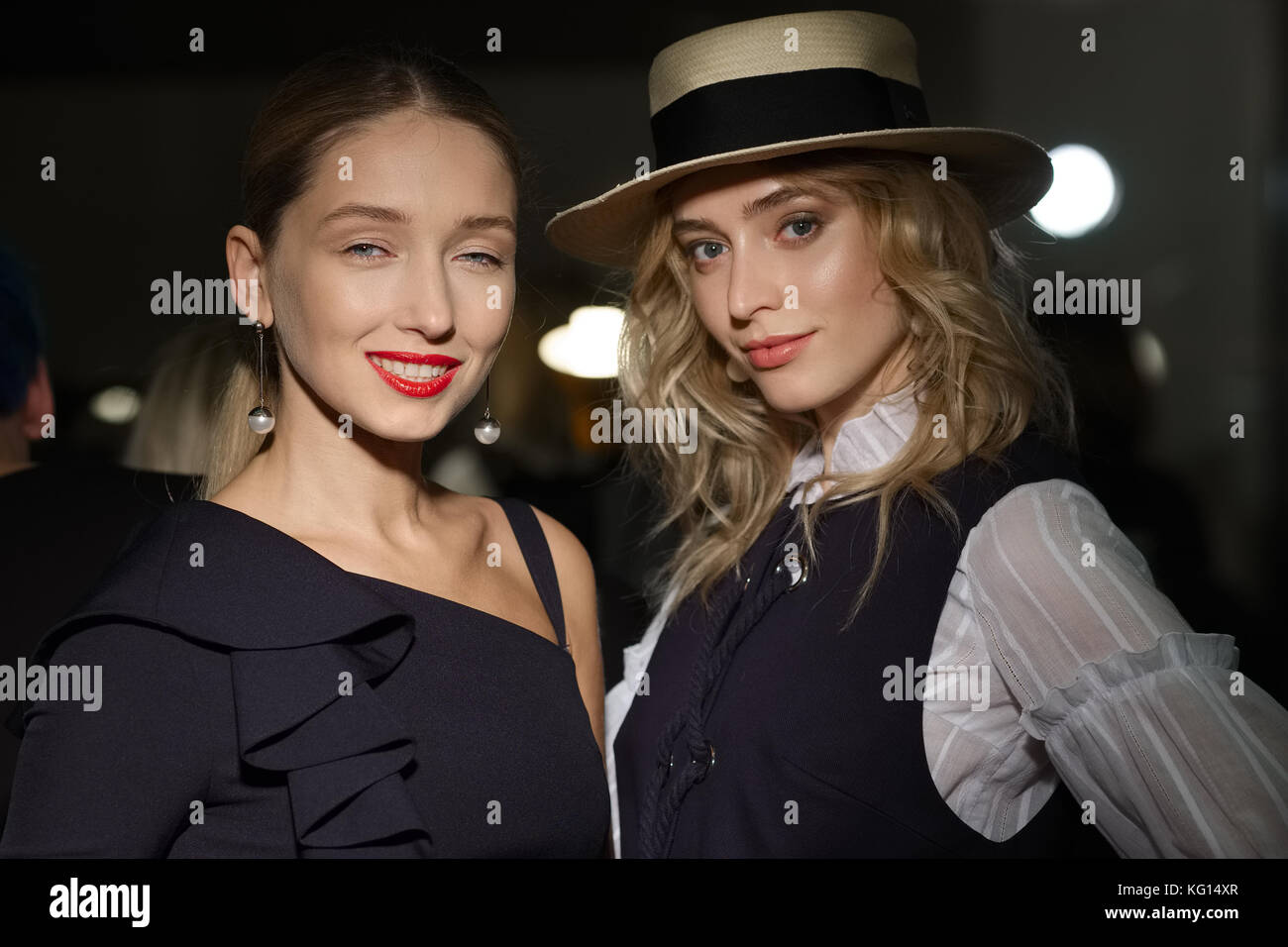 Two pretty models posing to camera at backstage of fashion week Stock ...