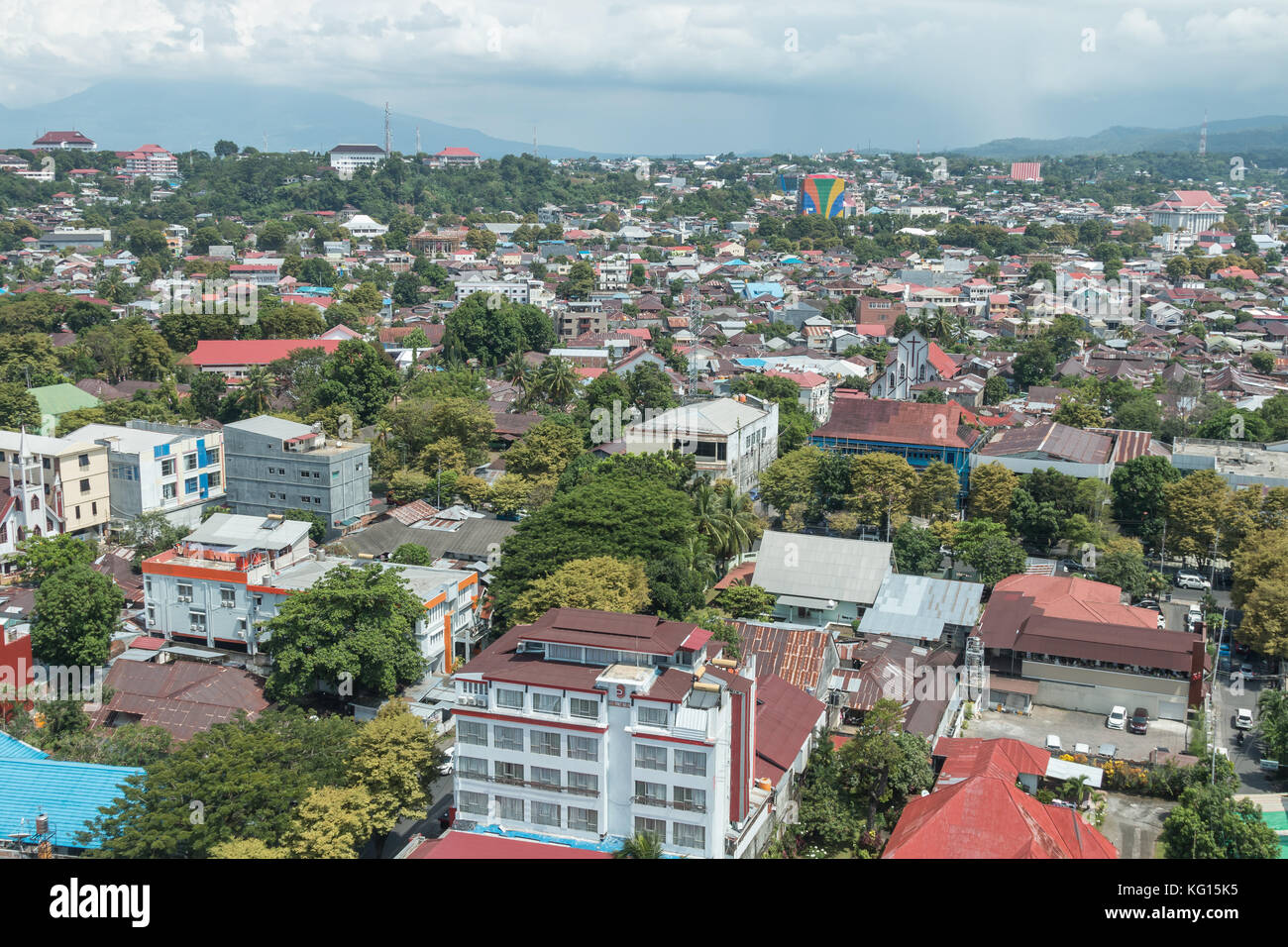 High view over buildings and rooftops of Manado City, North Sulawesi ...