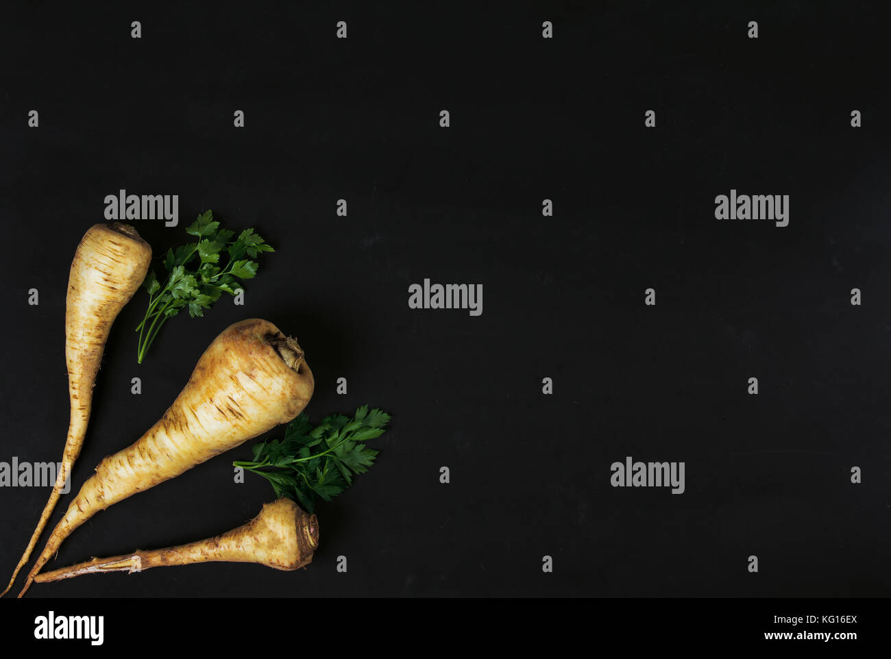 fresh parsnip on black background Stock Photo - Alamy