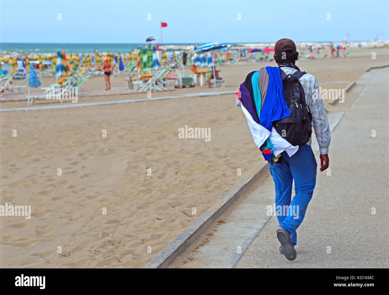 poor walking salesman along the beach in summer Stock Photo - Alamy