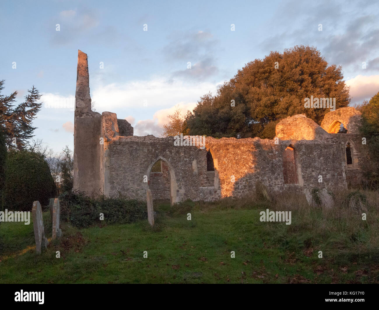soft sunset light on old ruined burnt down Alresford Church outside ...