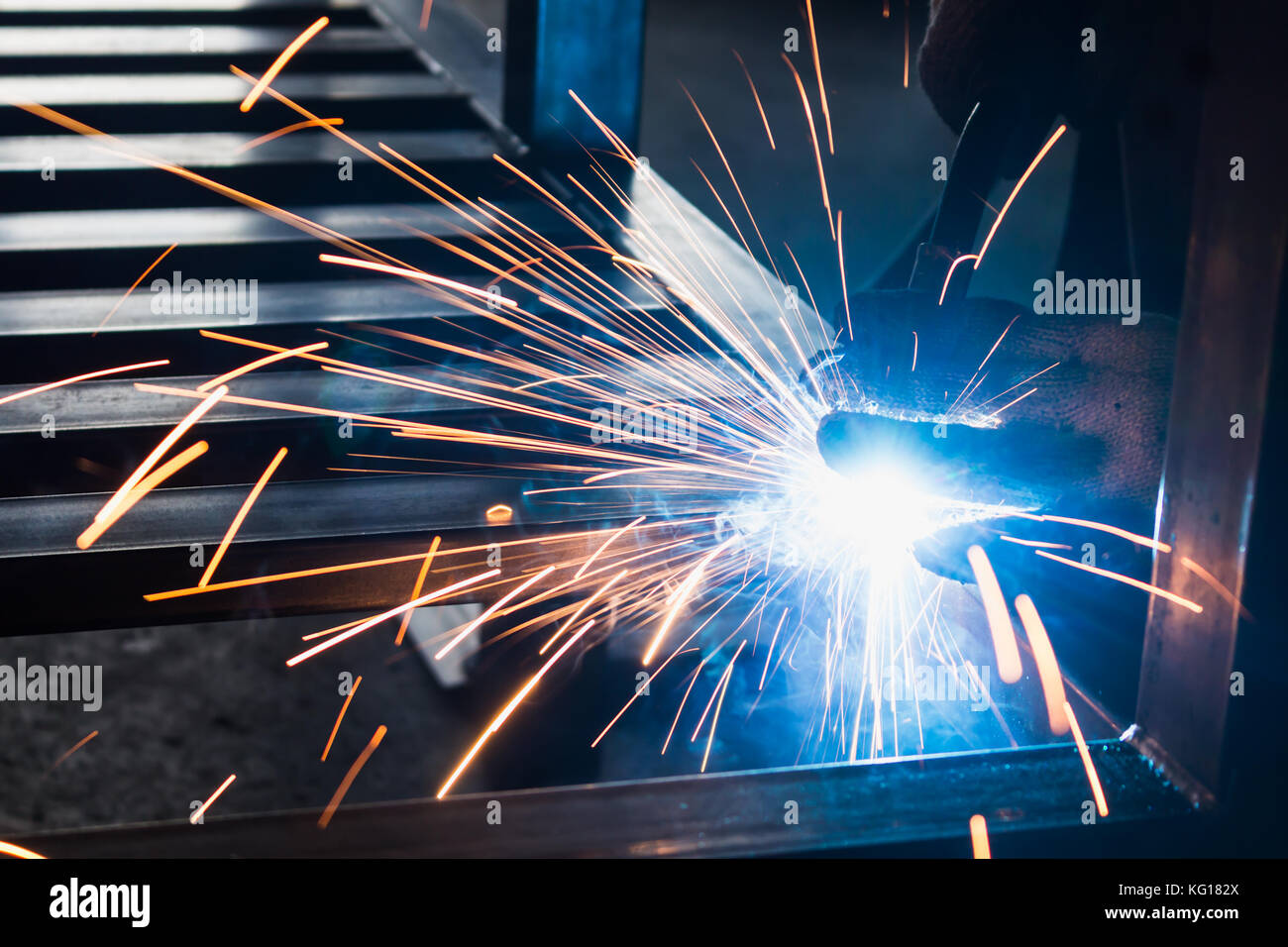 Worker welding metal work blue arc with copy space Stock Photo - Alamy
