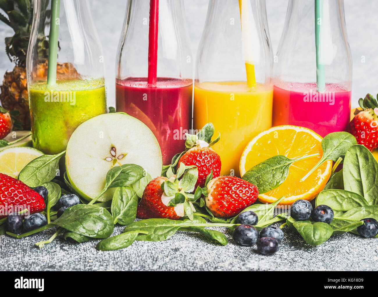 Various colorful beverage in bottles with fresh organic ingredients ...