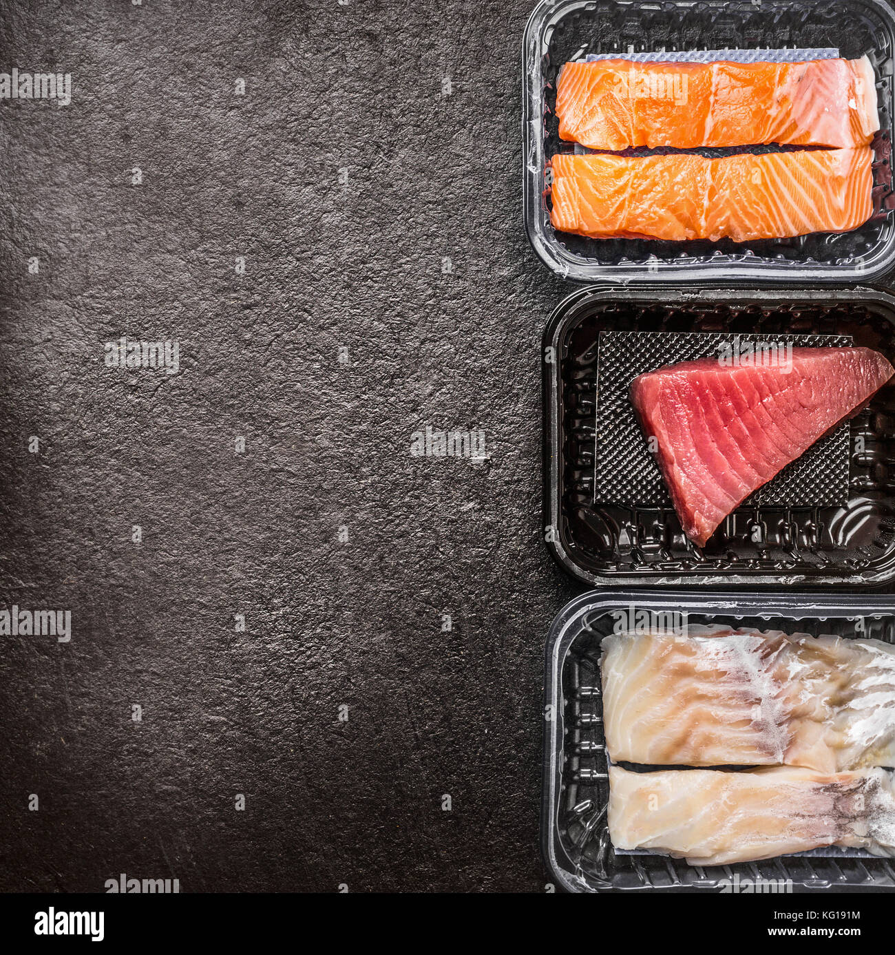 Various of raw fish fillets : salmon, tuna and codfish in plastic boxes ...