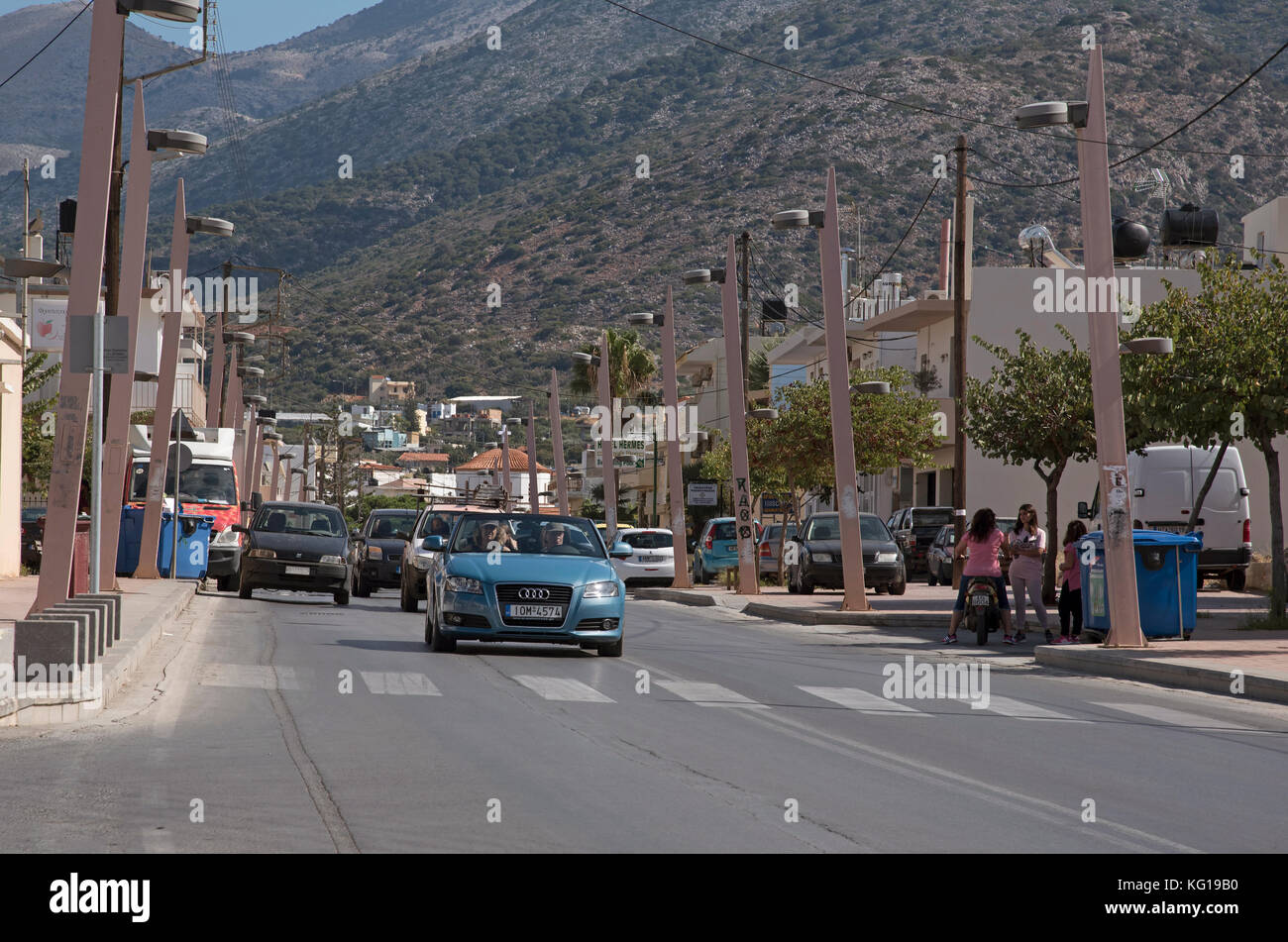 Traffic passing through Malia a Cretan town on the north coast of Crete ...