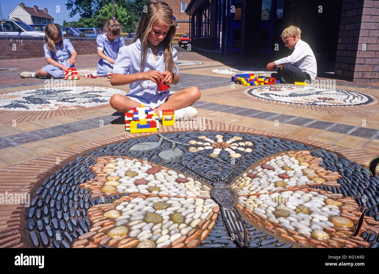Children in the school playground building with lego Stock Photo - Alamy