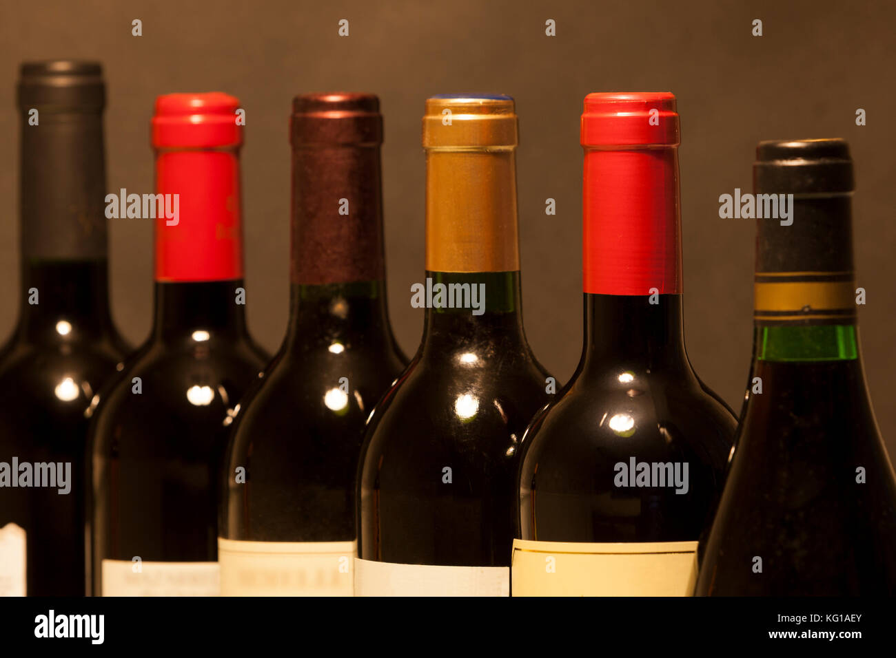 Selective focus on red wine bottles in a row Stock Photo - Alamy