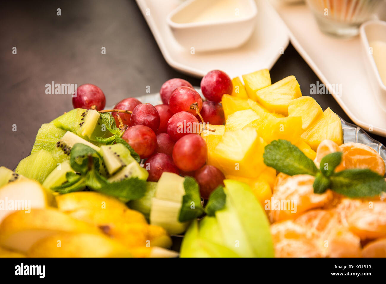 Fruits on plate with passionfruit. restaurant feed Stock Photo - Alamy