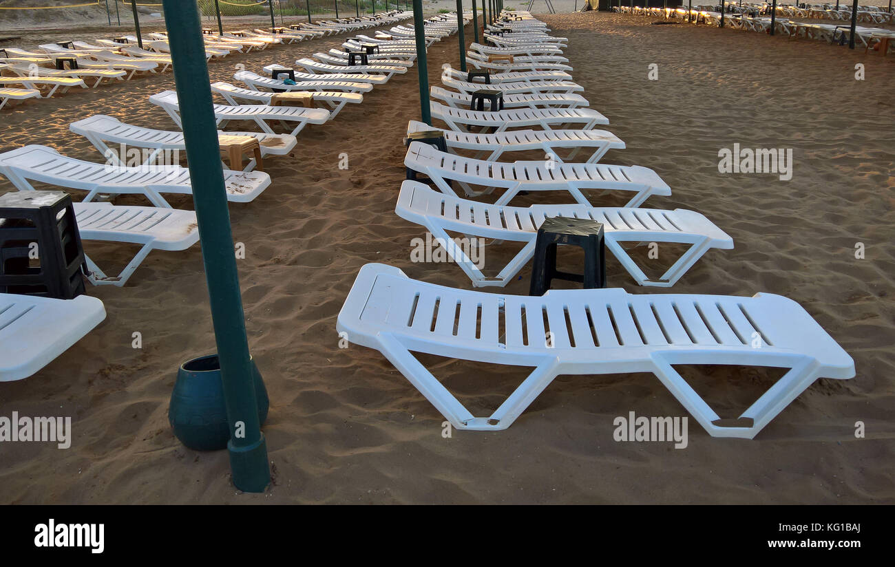Sun beds by the beach and swimming pool Stock Photo - Alamy