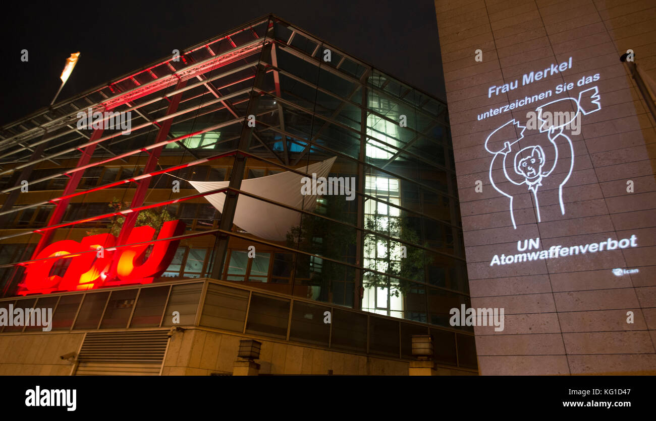 "Mrs. Merkel - sign the UN Nuclear Weapons Ban" displayed on a building ...
