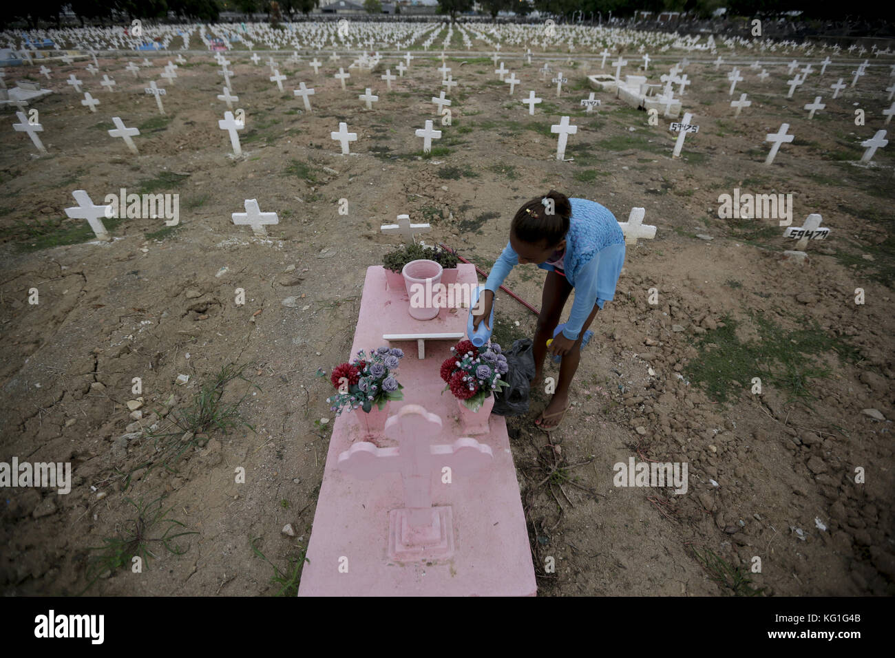 Girl works cleaning tomb on the day of the dead. 2nd Nov, 2017. Photo ...