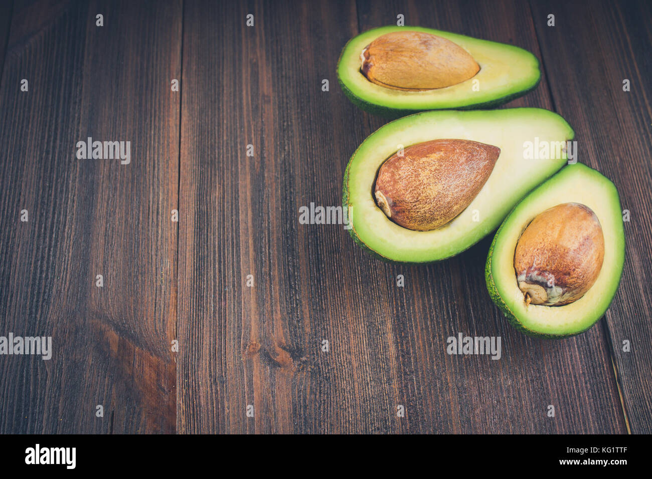 food background with fresh organic avocado on old wooden table, top ...
