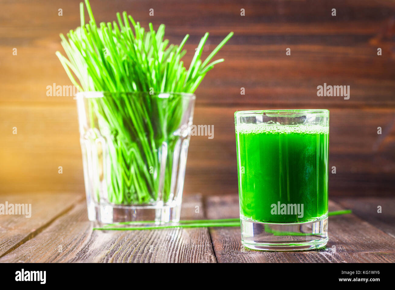 Wheatgrass shot. Juice from wheat grass. Trend of health Stock Photo ...