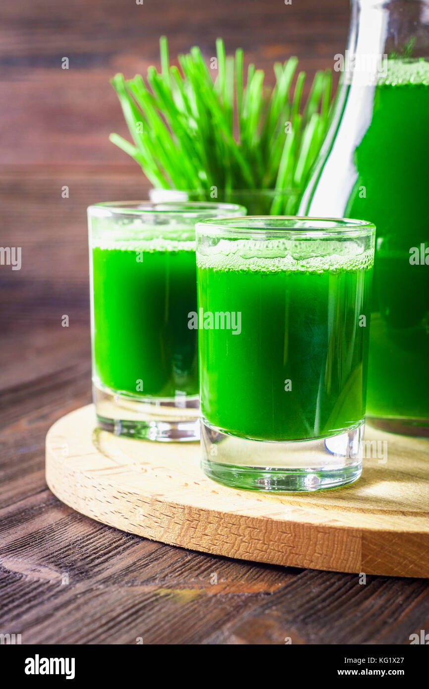Wheatgrass shot. Juice from wheat grass. Trend of health Stock Photo ...