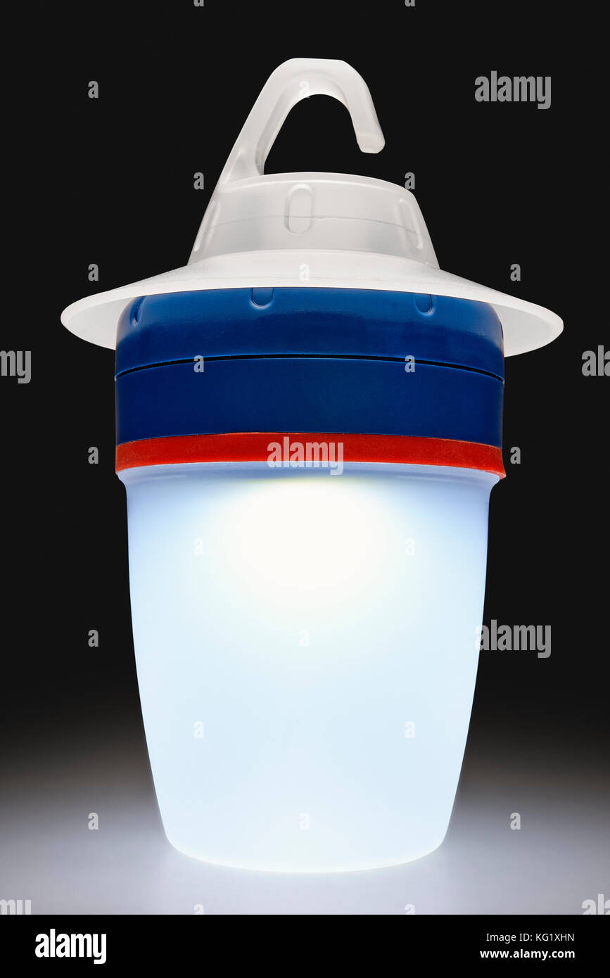 Modern plastic camping light on table illuminated and isolated Stock ...
