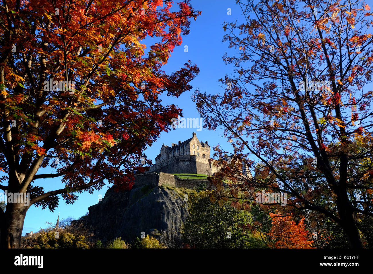 Edinburgh Castle is surrounded by the Autumn colours of the trees in ...