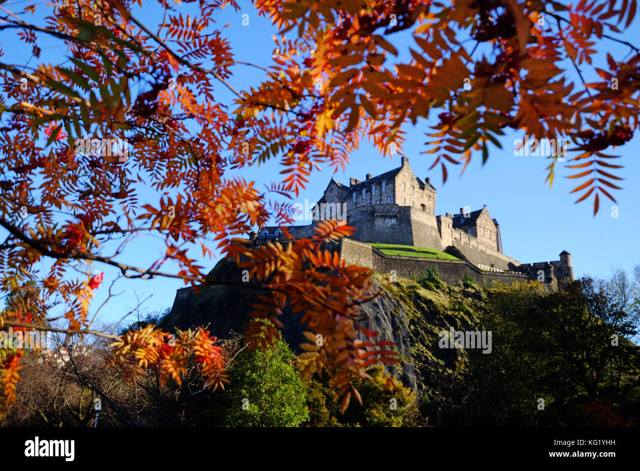 Edinburgh Castle is surrounded by the Autumn colours of the trees in ...