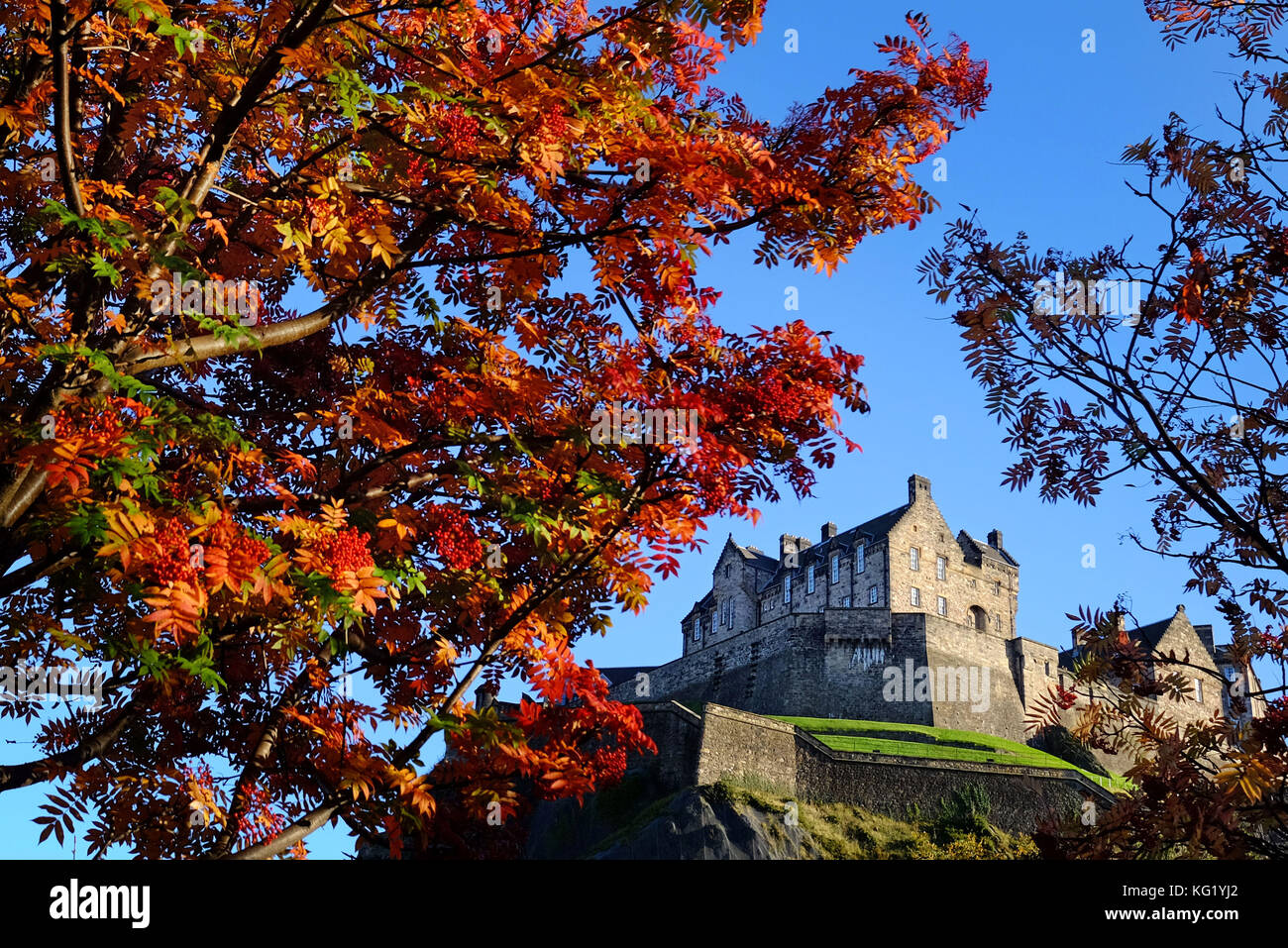 Edinburgh Castle is surrounded by the Autumn colours of the trees in ...