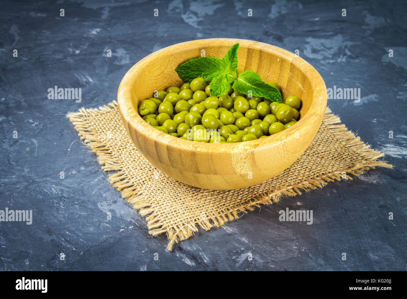 Canned peas in a wooden plate on a gray concrete background Stock Photo ...