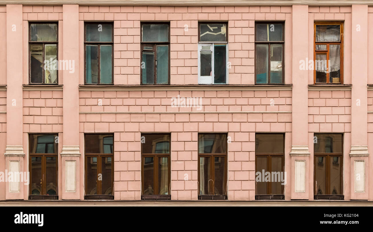 Several windows in a row on facade of urban apartment building front ...