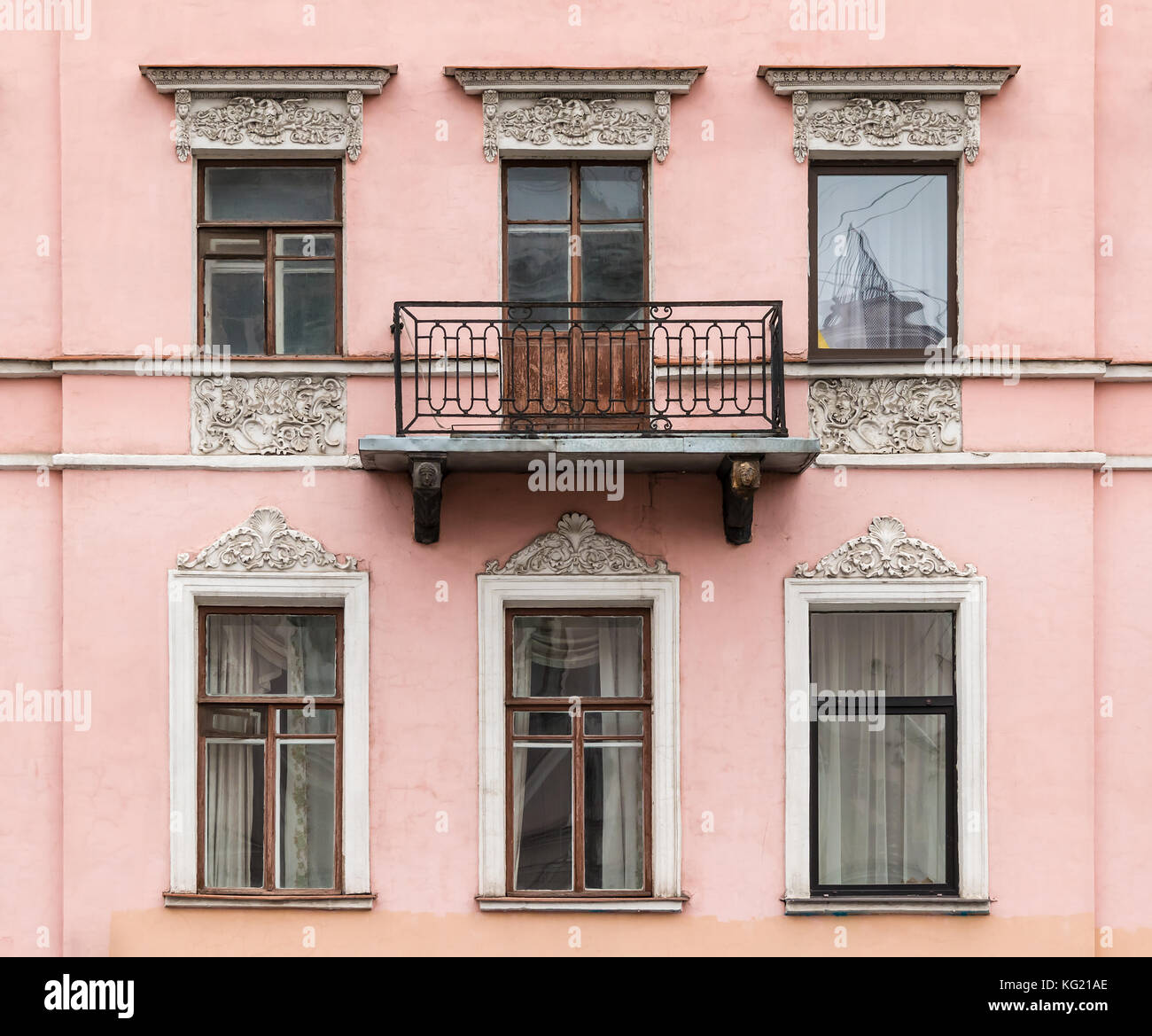 Several windows in a row and balcony on facade of urban apartment ...