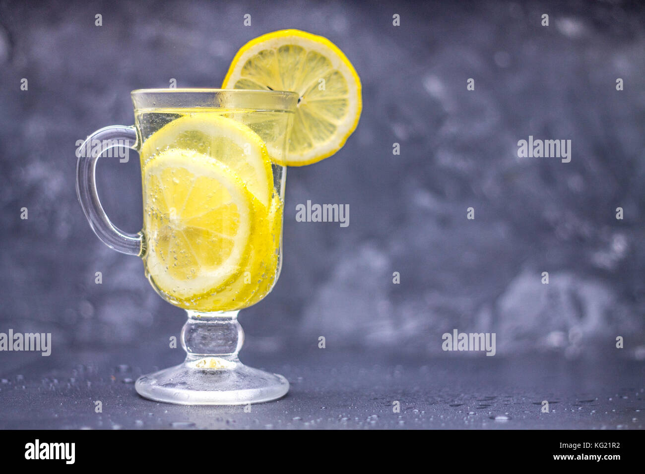 Homemade lemonade in a glass with a handle on a gray concrete ...