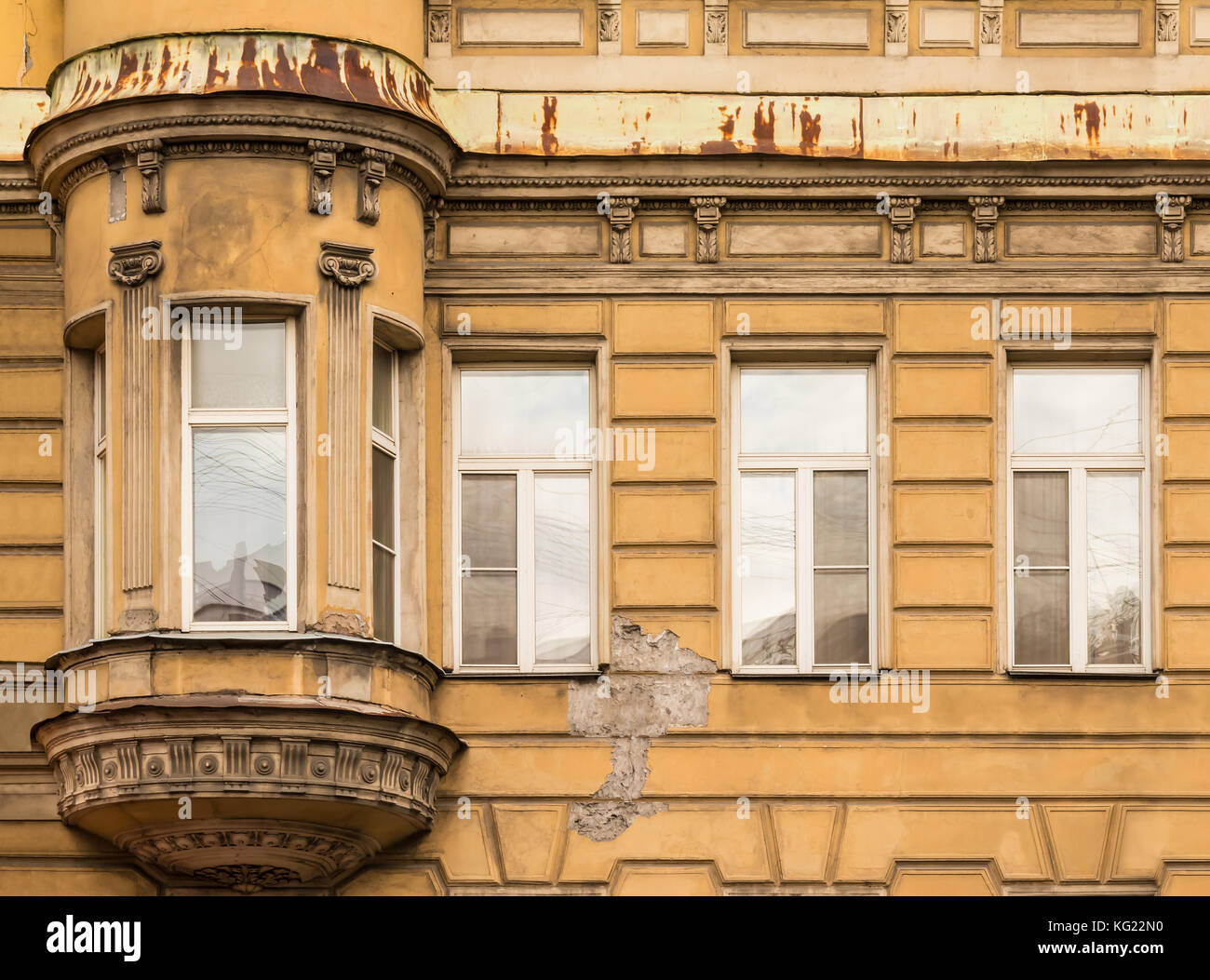Several windows in a row and bay window on facade of urban apartment ...