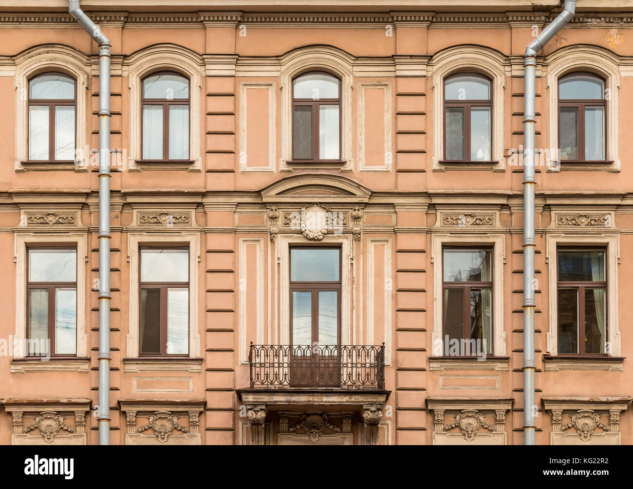 Several windows in a row nd balcony on facade of urban apartment ...