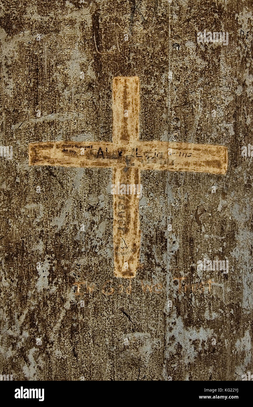 Religious cross graffiti etched on a metal wall in an old jail Stock ...