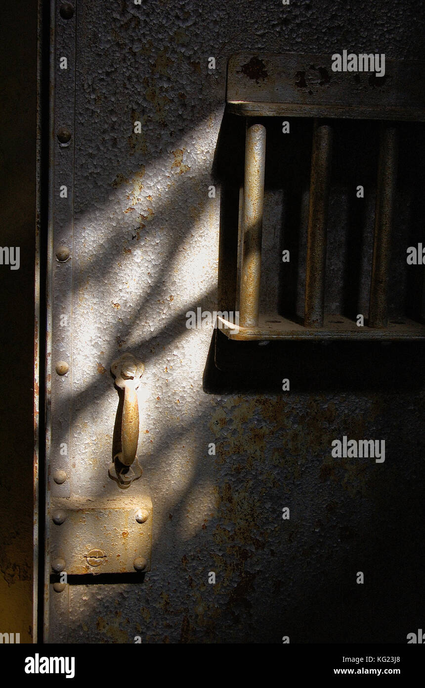 Heavy steel prison door in old jail with window Stock Photo - Alamy