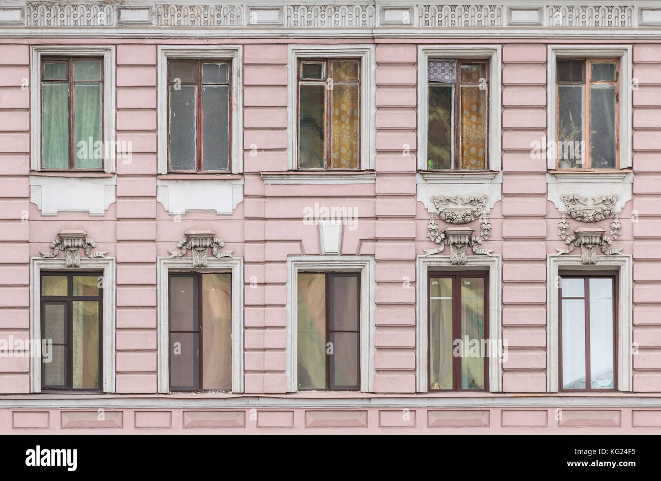 Several windows in a row on facade of urban apartment building front ...