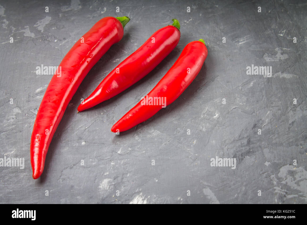 Red chili peppers. Grey marble background Stock Photo - Alamy