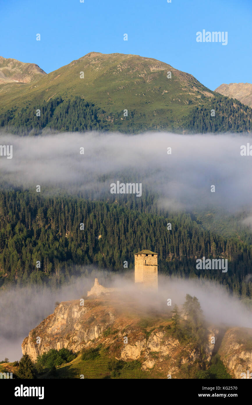 Tower of Steinsberg Castle framed by woods, Ardez, district of Inn ...