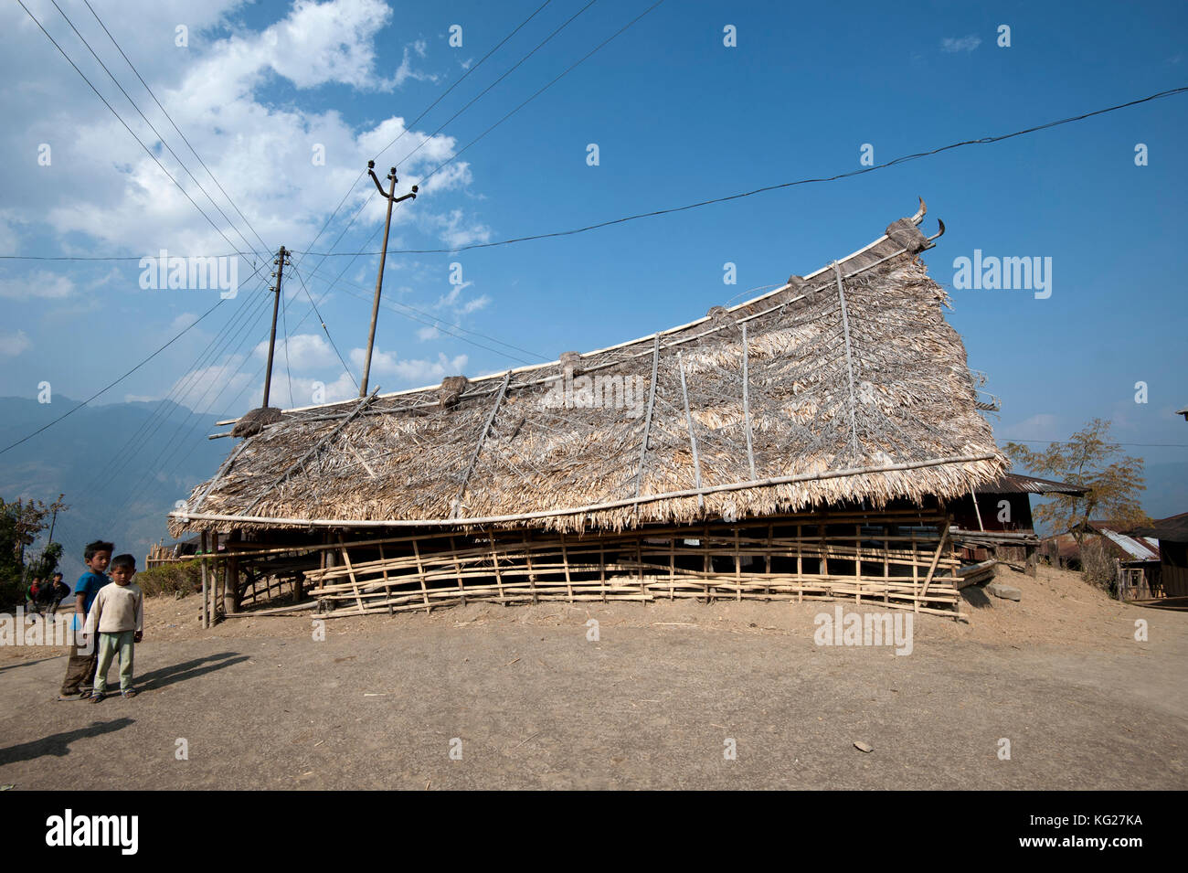 Naga children beside small bamboo constructed, fan palm thatched murung ...