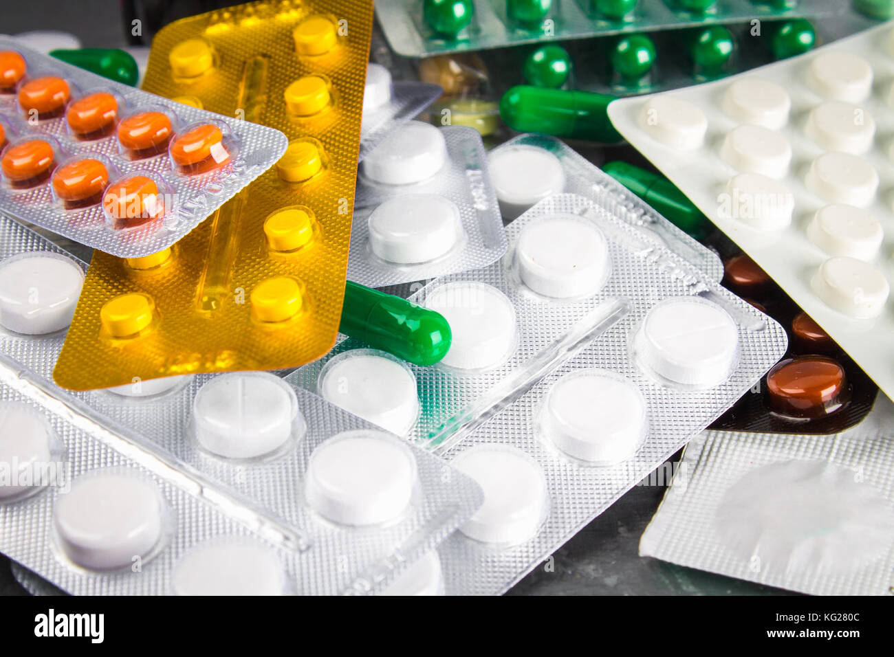 Multicolored blisters of tablets on a gray concrete background Stock ...