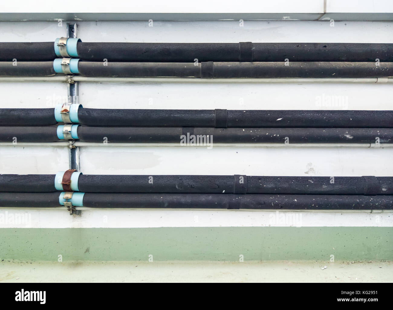 Thermo pipeline with the black rubber case of the air compressor unit ...