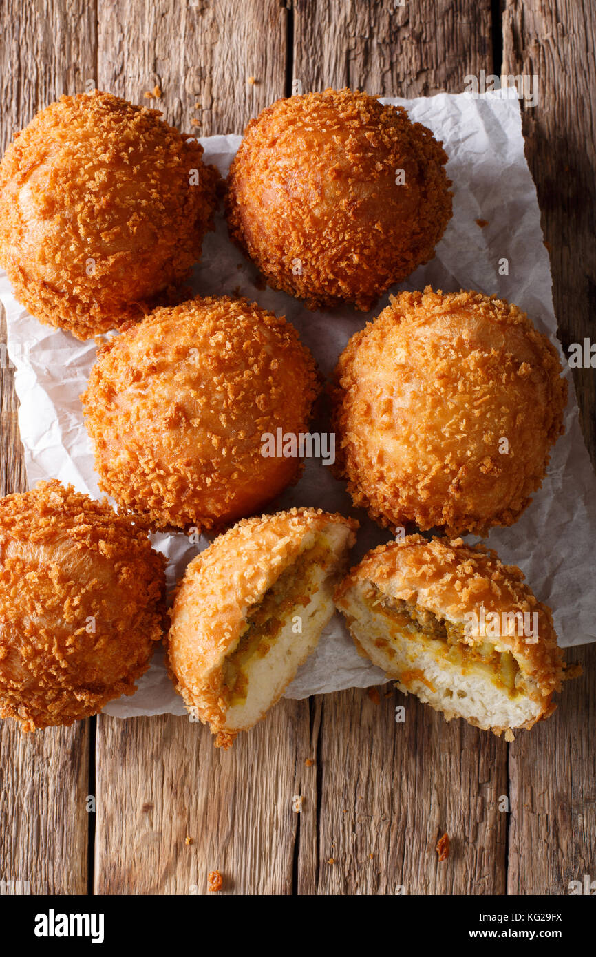 Homemade Japanese bread stuffed with curry kare pan macro on paper on ...